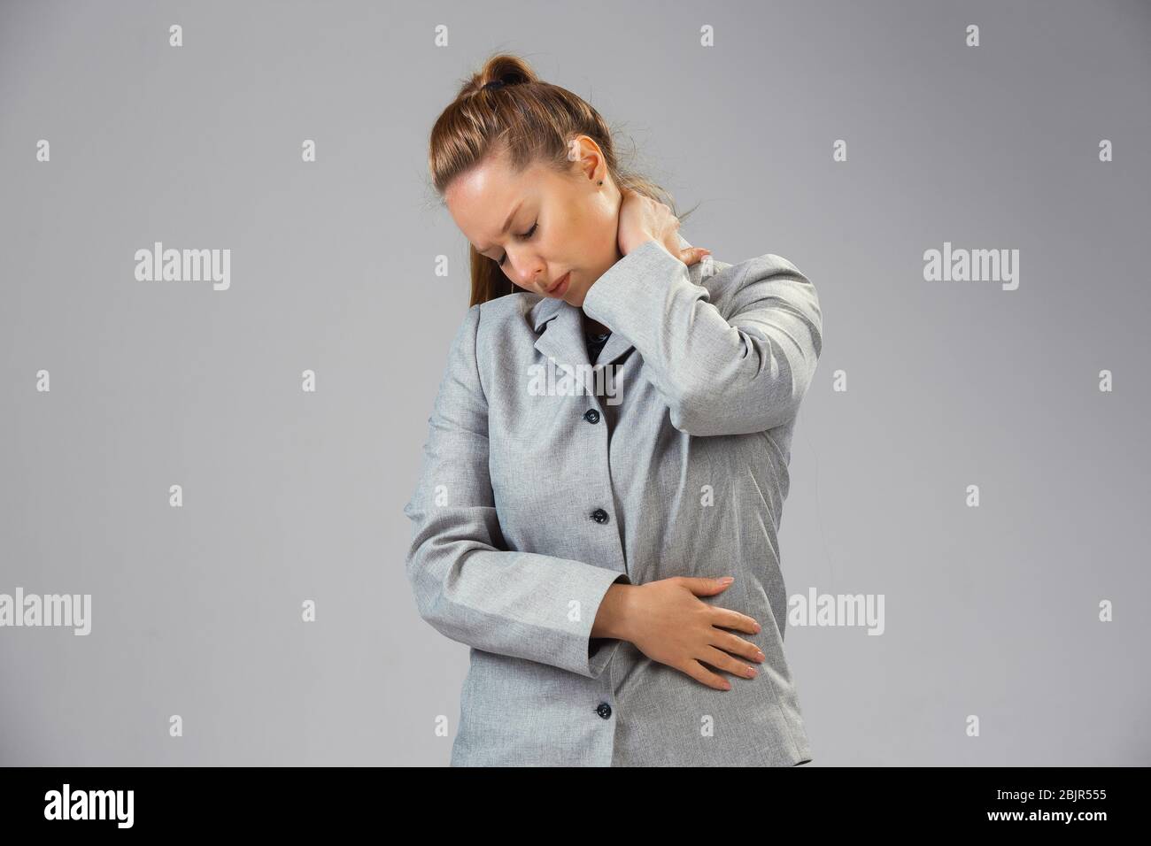 Young caucasian woman suffers from neck pain, feels sick, ill and ...