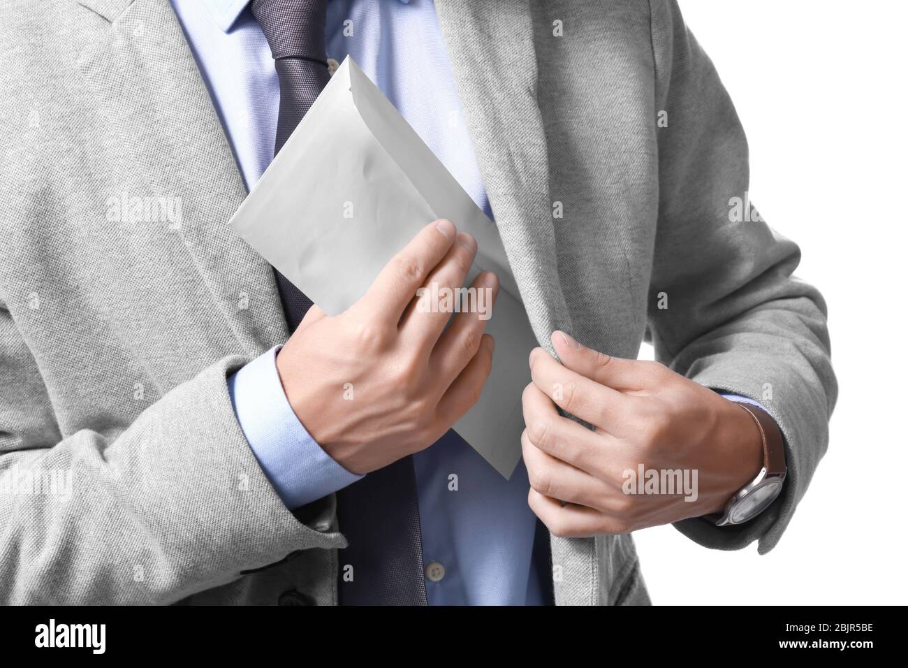Man in formal suit putting envelope with bribe in pocket on white ...