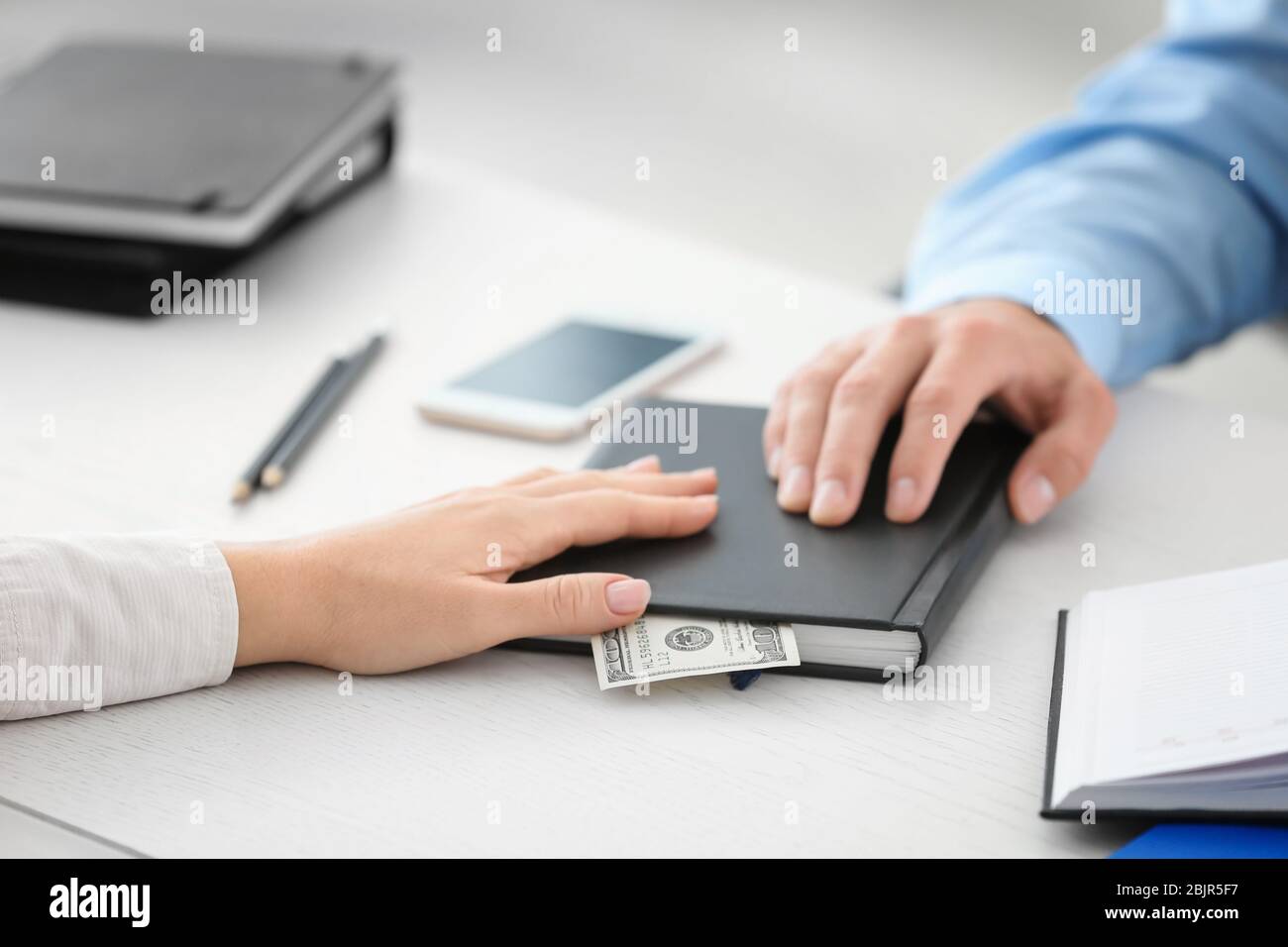 Woman giving bribe money hi-res stock photography and images - Alamy
