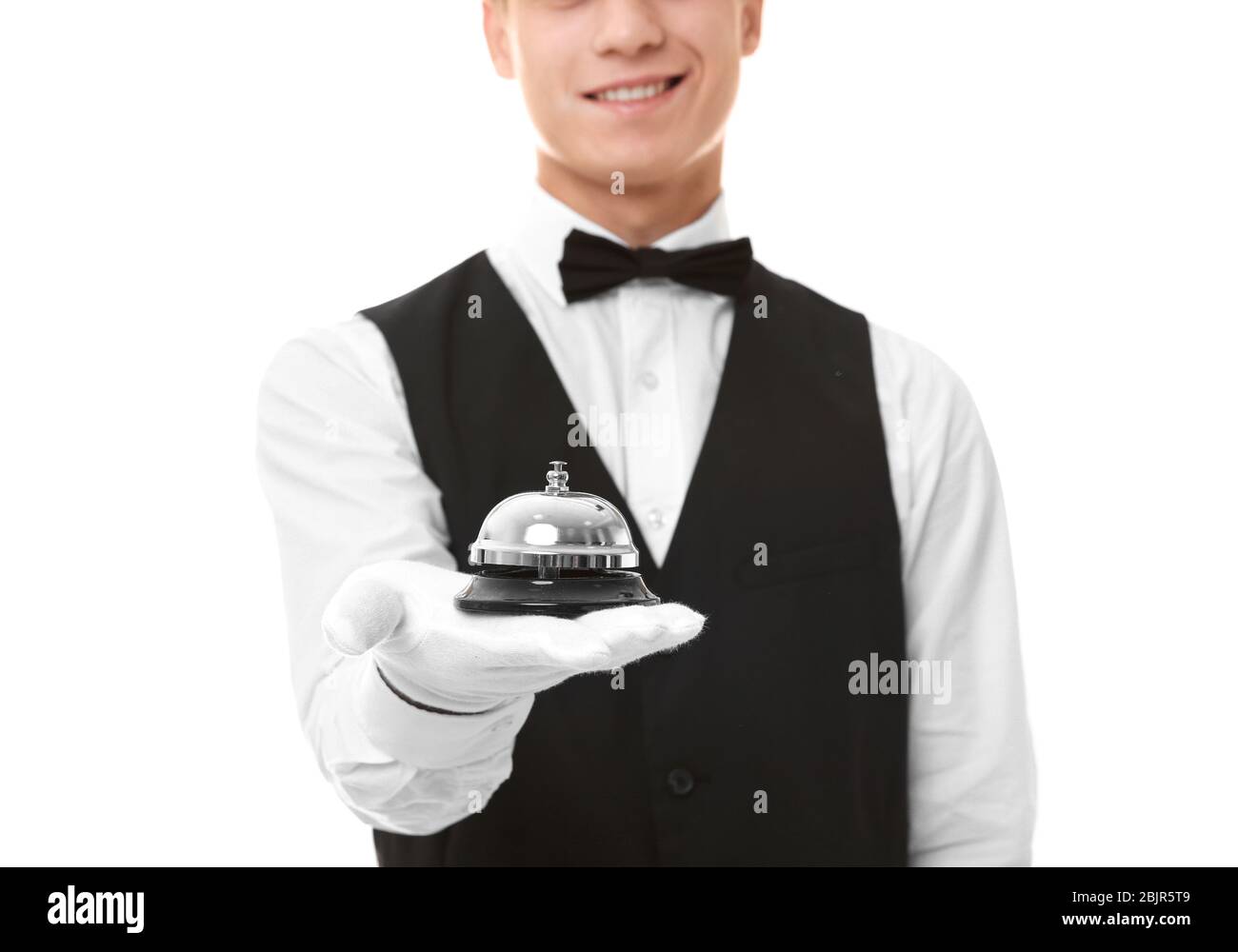 Waiter with service bell on white background Stock Photo - Alamy