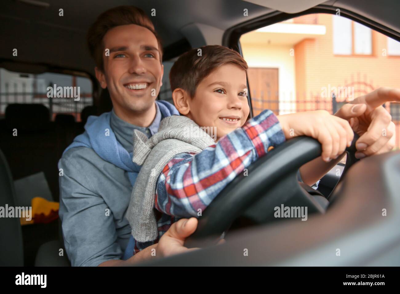 Father teaching son to drive car hi-res stock photography and images ...