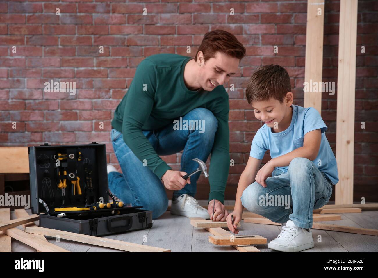 Father and his little son with tools in workshop Stock Photo - Alamy