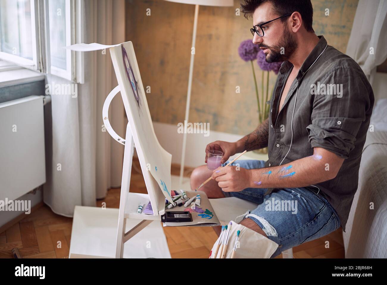 Man working creating arting process. Serious young male painting Stock ...