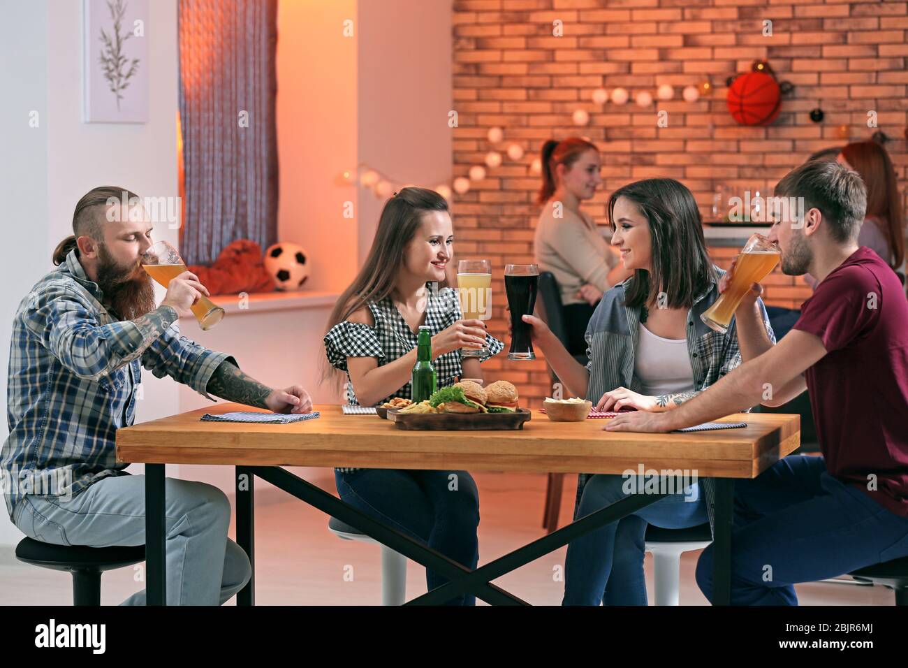 Friends with beer and snacks in sport bar Stock Photo - Alamy