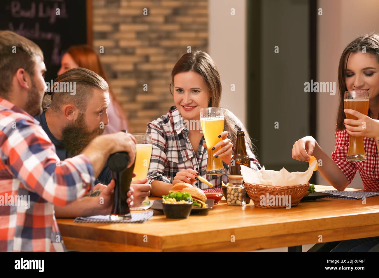 Friends with beer and snacks in sport bar Stock Photo - Alamy