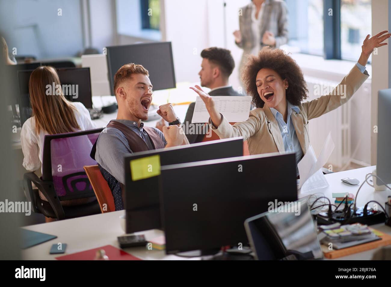 two colleagues, male and female, sharing a good news at work. woman ...