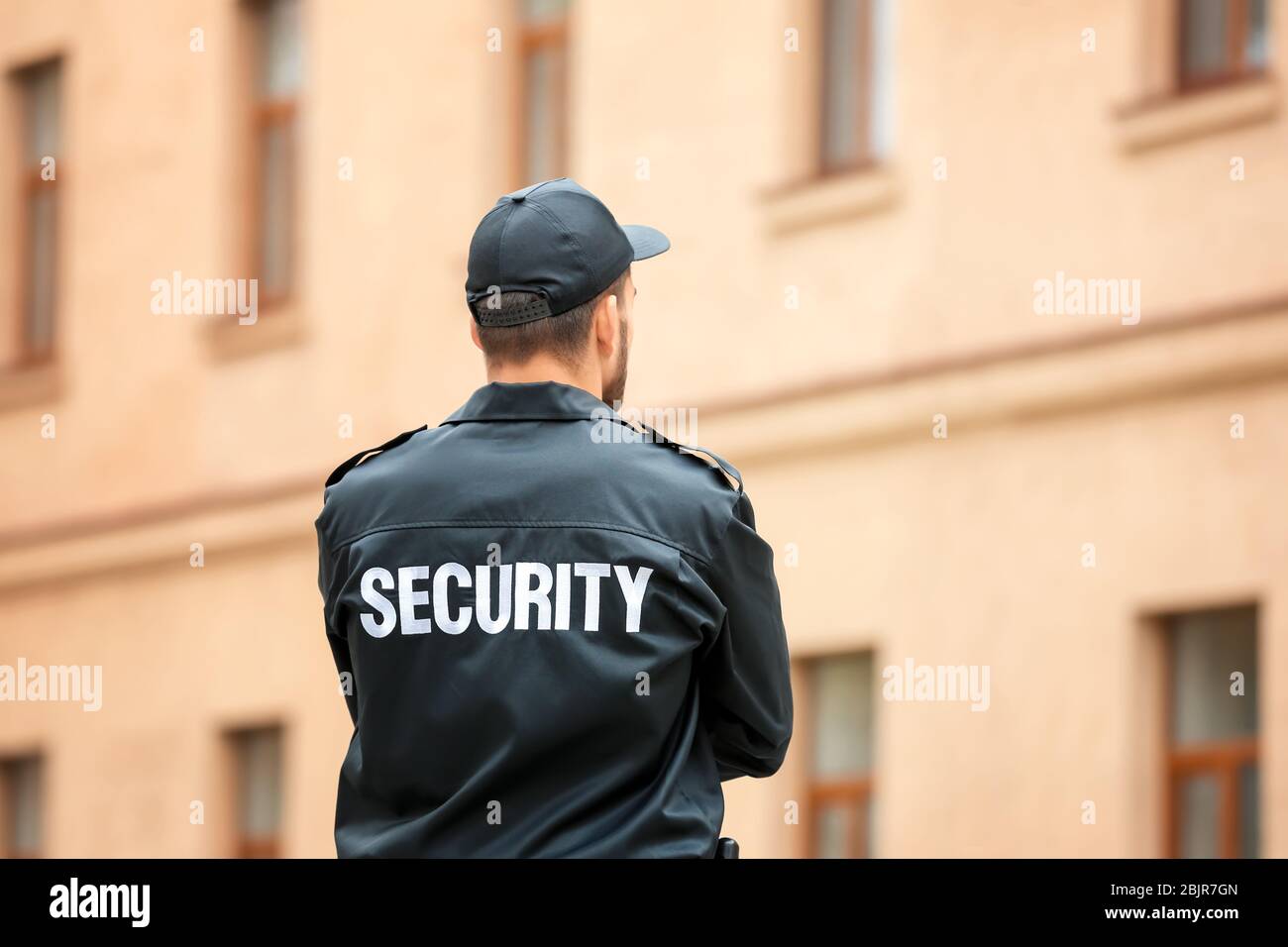 Male security guard on city street Stock Photo - Alamy