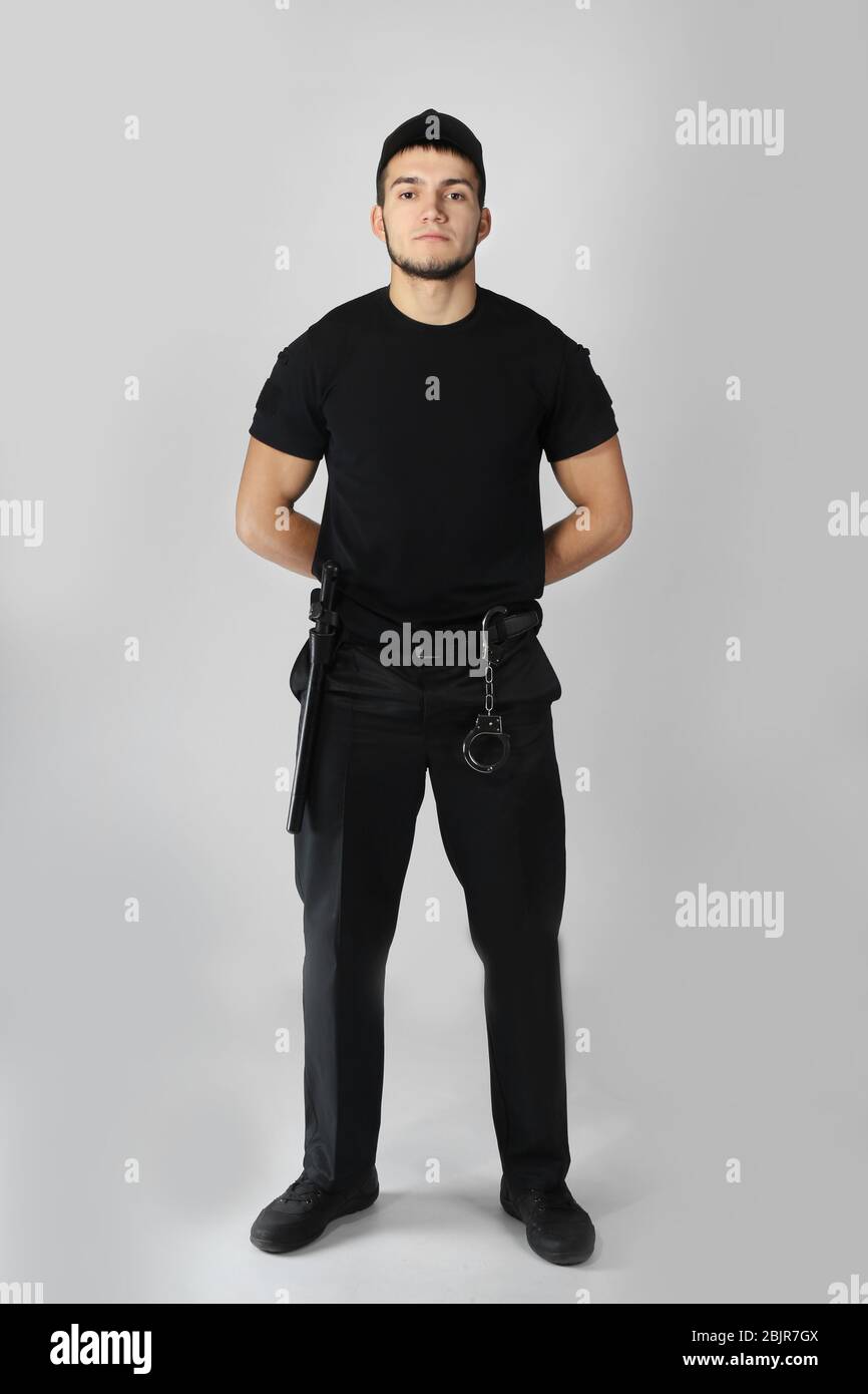 Male security guard on light background Stock Photo - Alamy