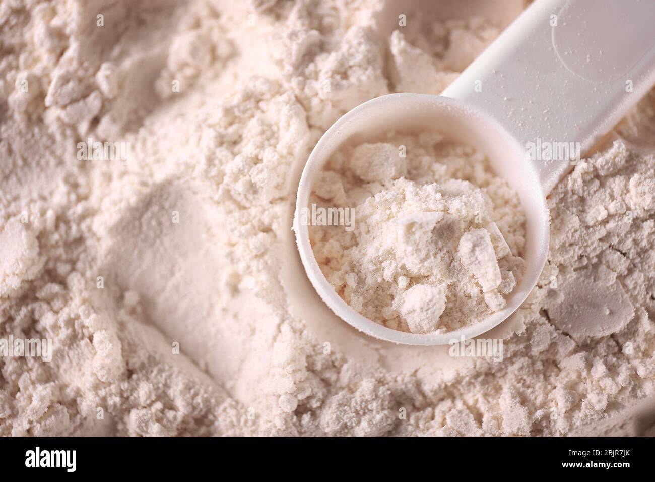 Protein powder and scoop, closeup Stock Photo - Alamy