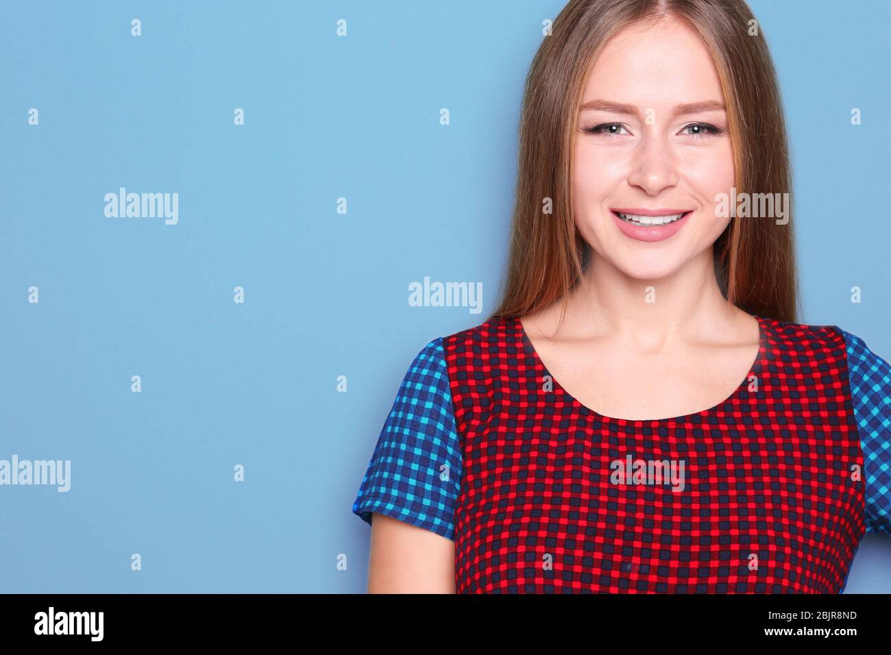 Beautiful young smiling woman on color background Stock Photo - Alamy