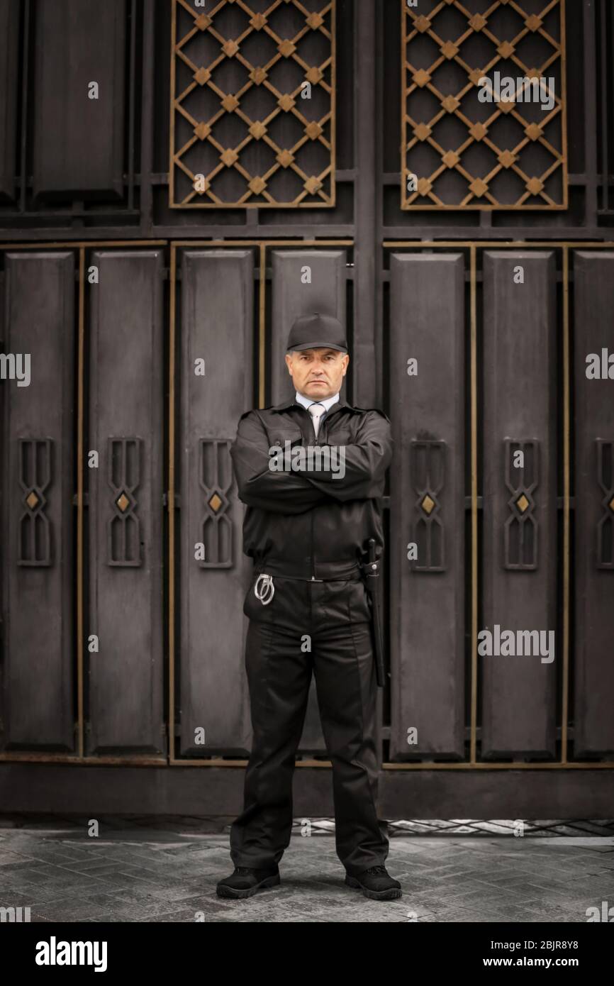 Security guard standing arms crossed hi-res stock photography and ...