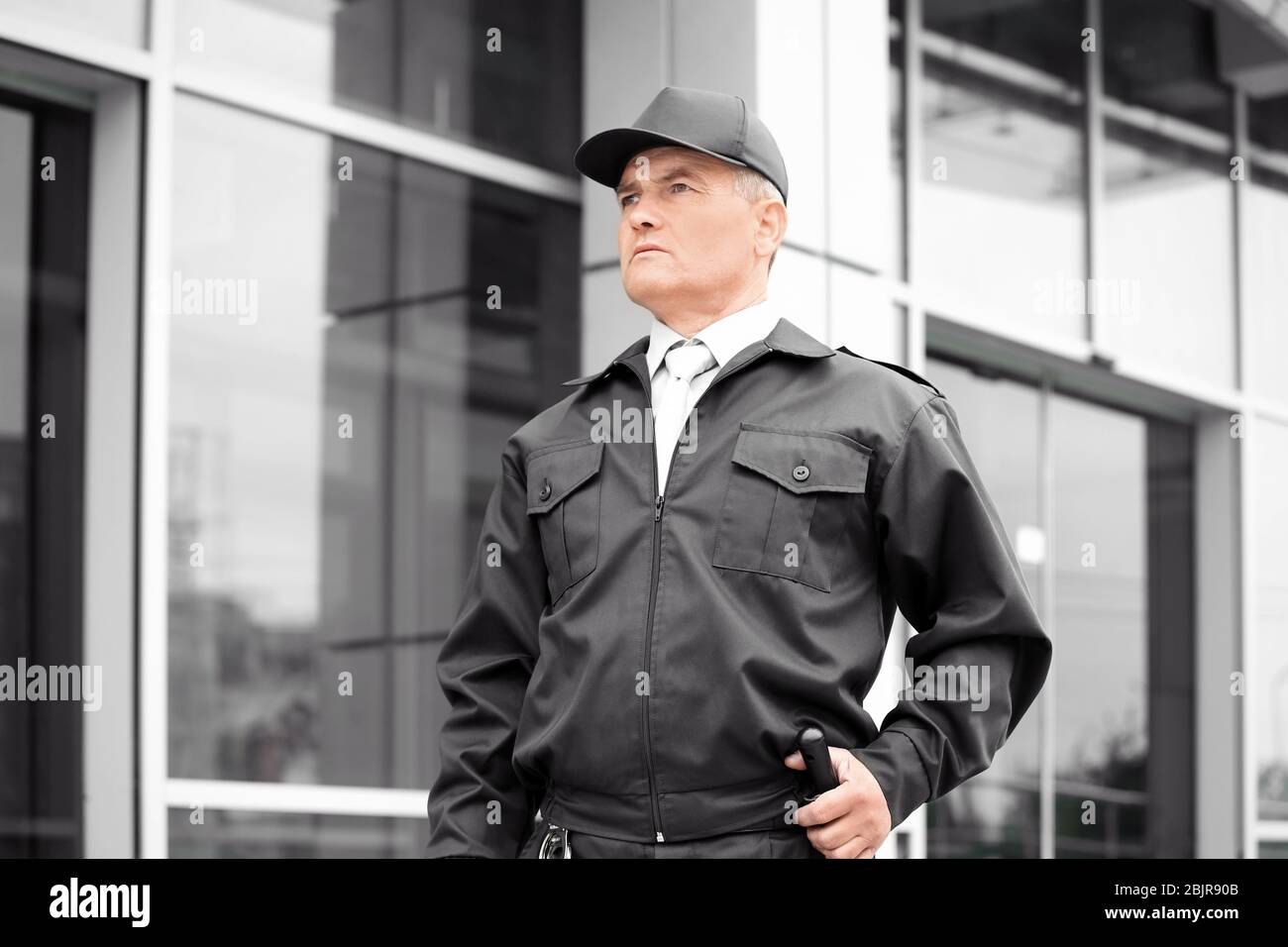 Male security guard standing outdoors Stock Photo - Alamy