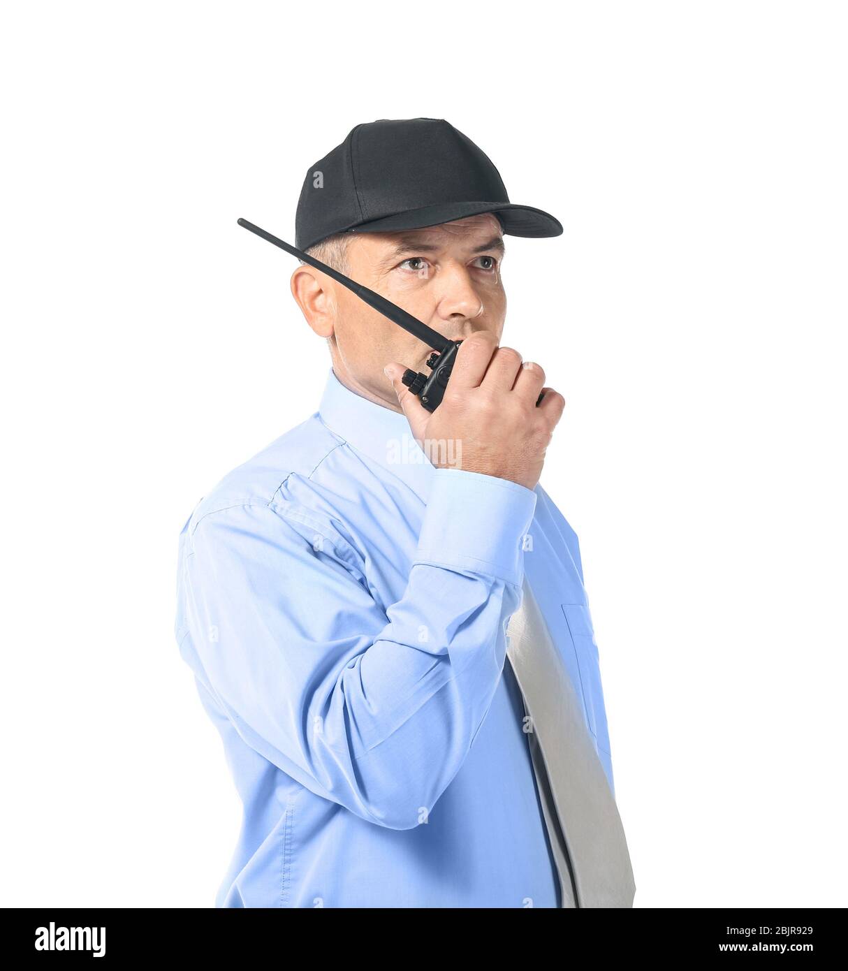 Male security guard using portable radio on white background Stock ...