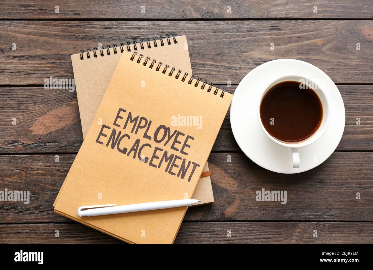 Notepad with text EMPLOYEE ENGAGEMENT and coffee on table Stock Photo ...