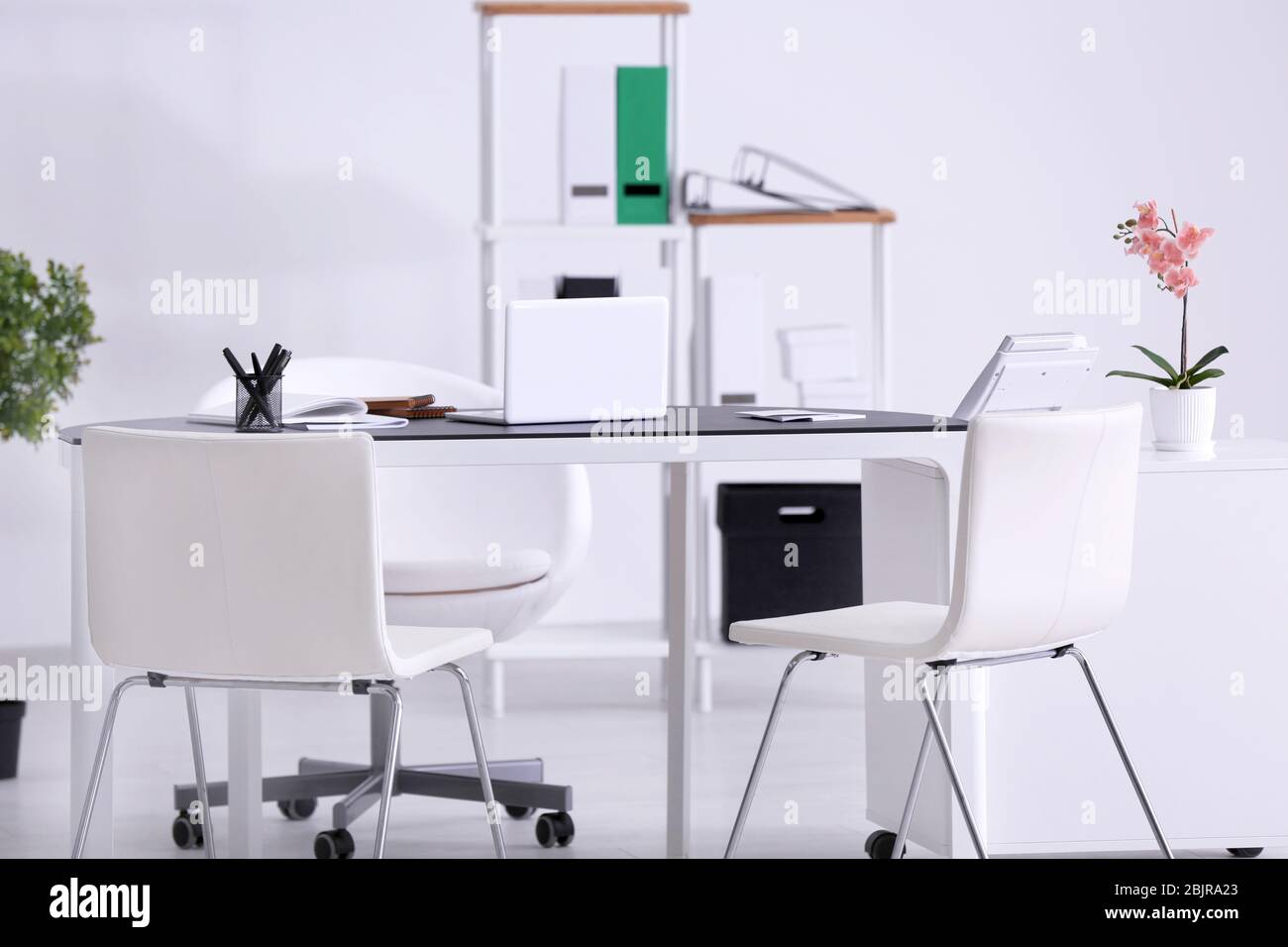 Modern office interior with table and white chairs Stock Photo - Alamy