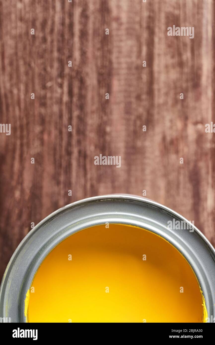 Tin can with bright yellow paint on blurred background, closeup Stock ...