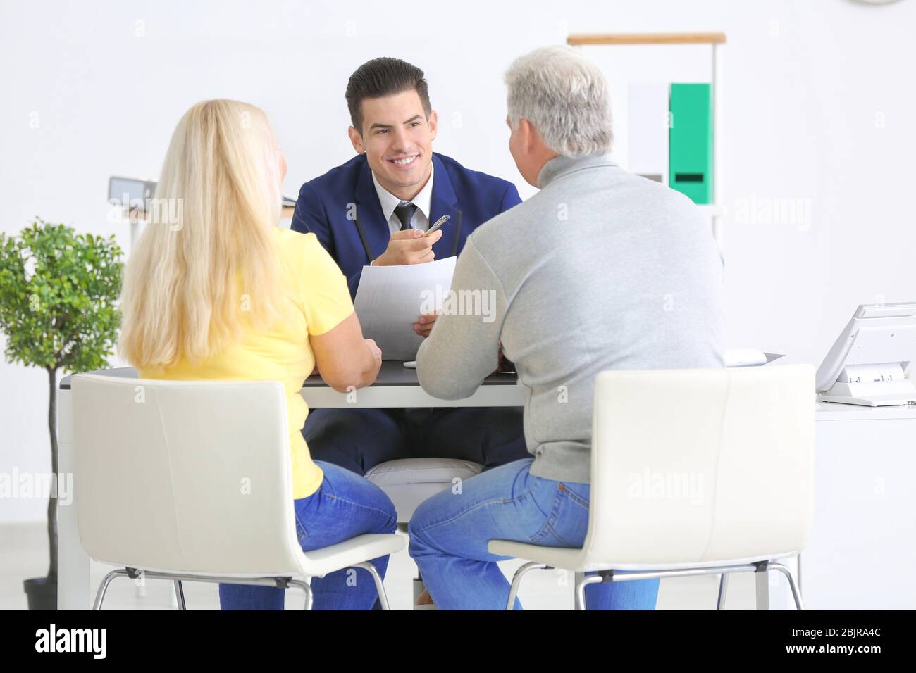 Senior couple meeting with consultant in office Stock Photo - Alamy
