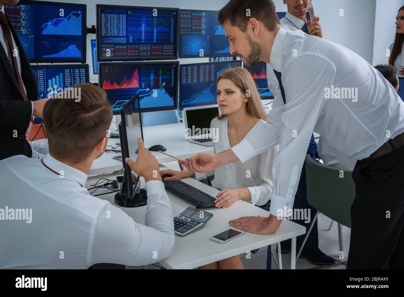 Stock traders working in office Stock Photo - Alamy