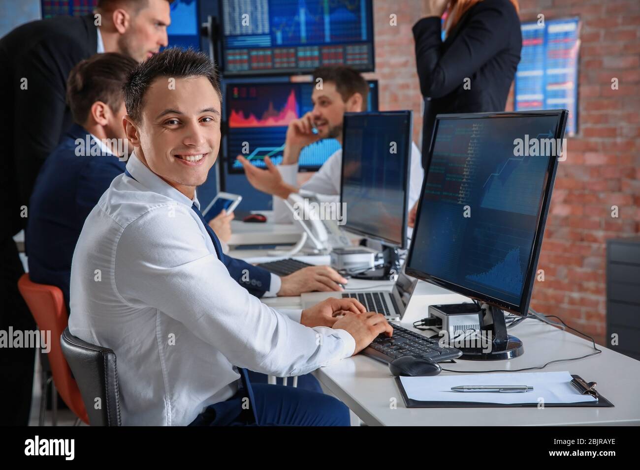 Stock traders working in office Stock Photo - Alamy