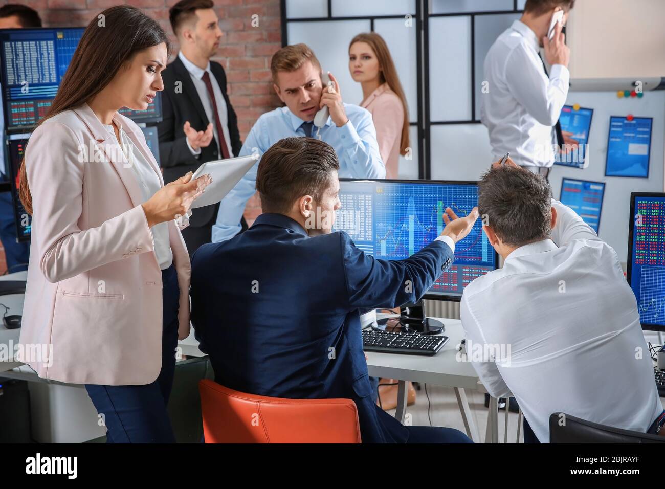 Stock traders working in office Stock Photo - Alamy