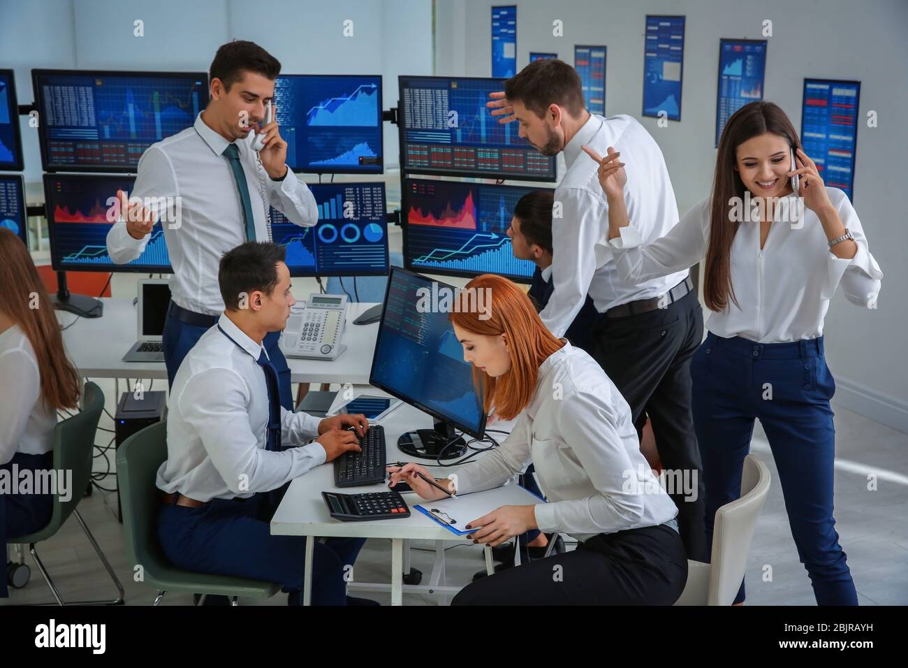 Stock traders working in office Stock Photo - Alamy