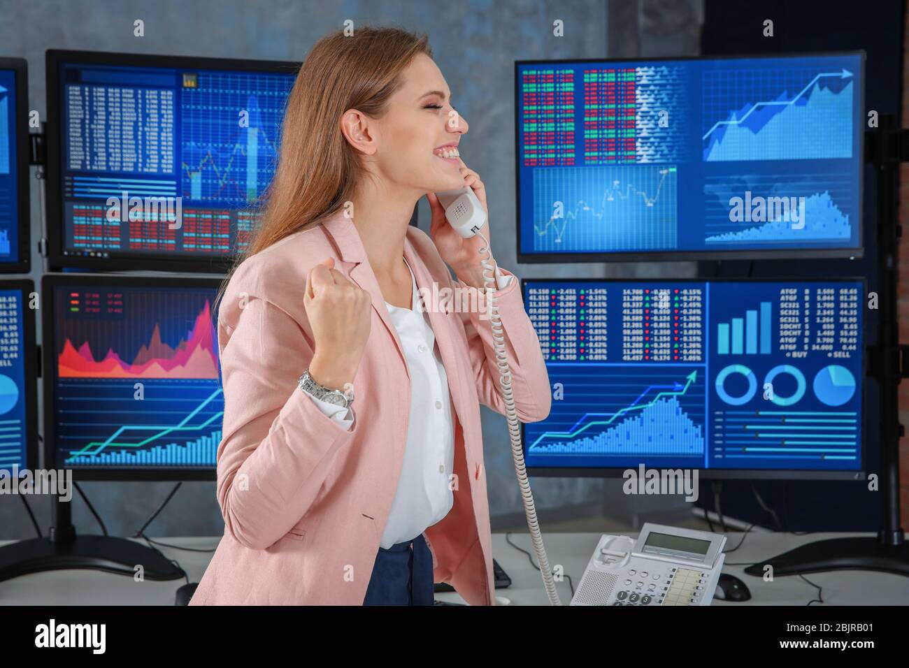 Female stock trader working in office Stock Photo - Alamy