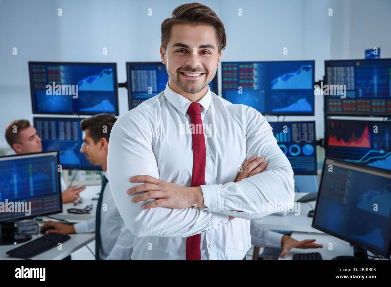 Male stock trader working in office Stock Photo - Alamy