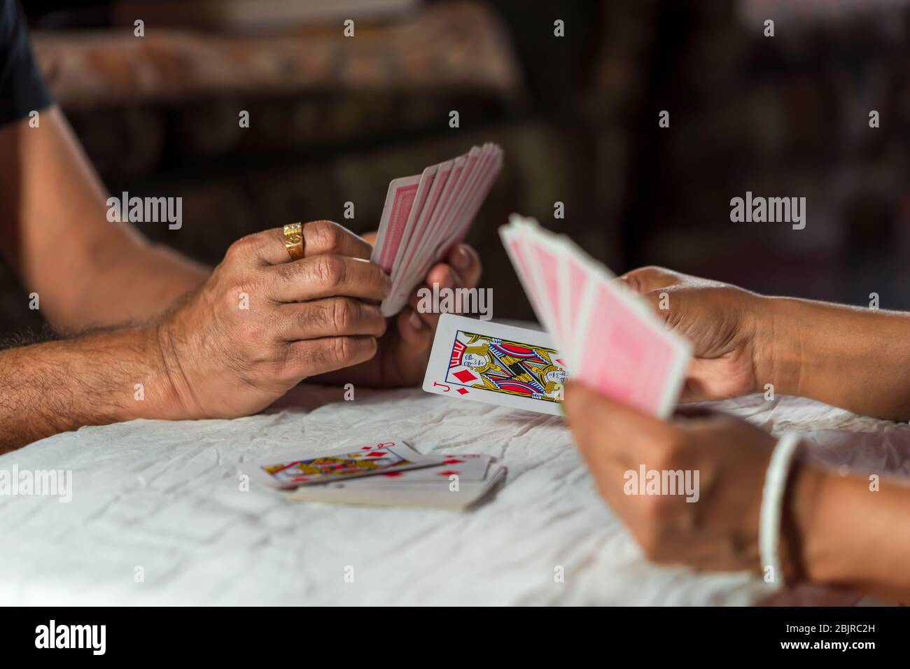 Couple stay at home during quarantine and enjoying playing cards ...