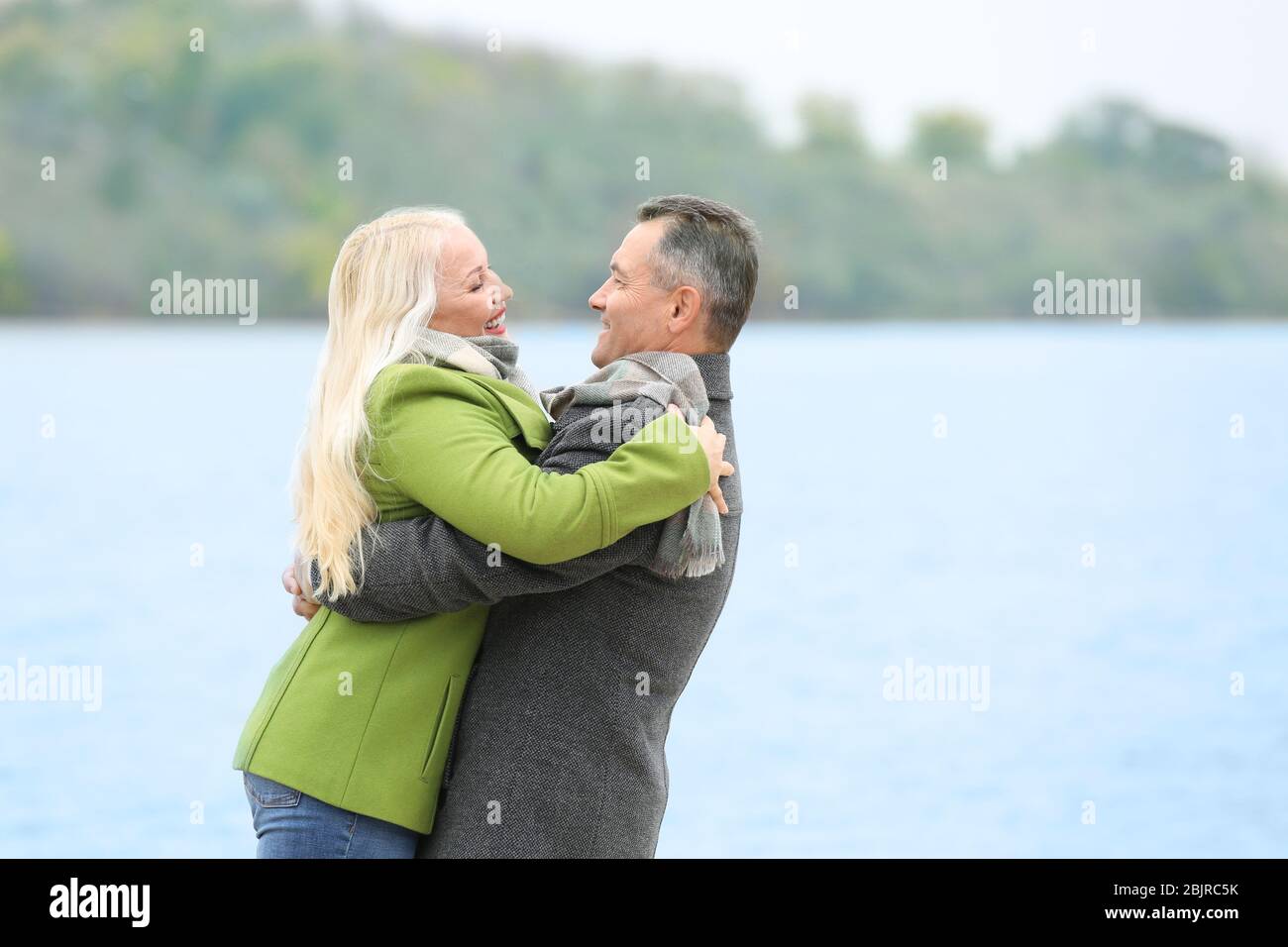 Loving couple on background river hi-res stock photography and images ...