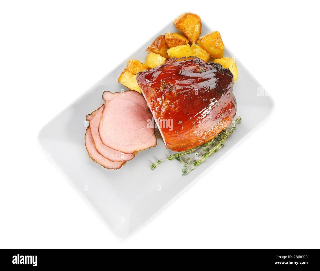 Plate with traditional honey baked ham and potatoes, isolated on white ...