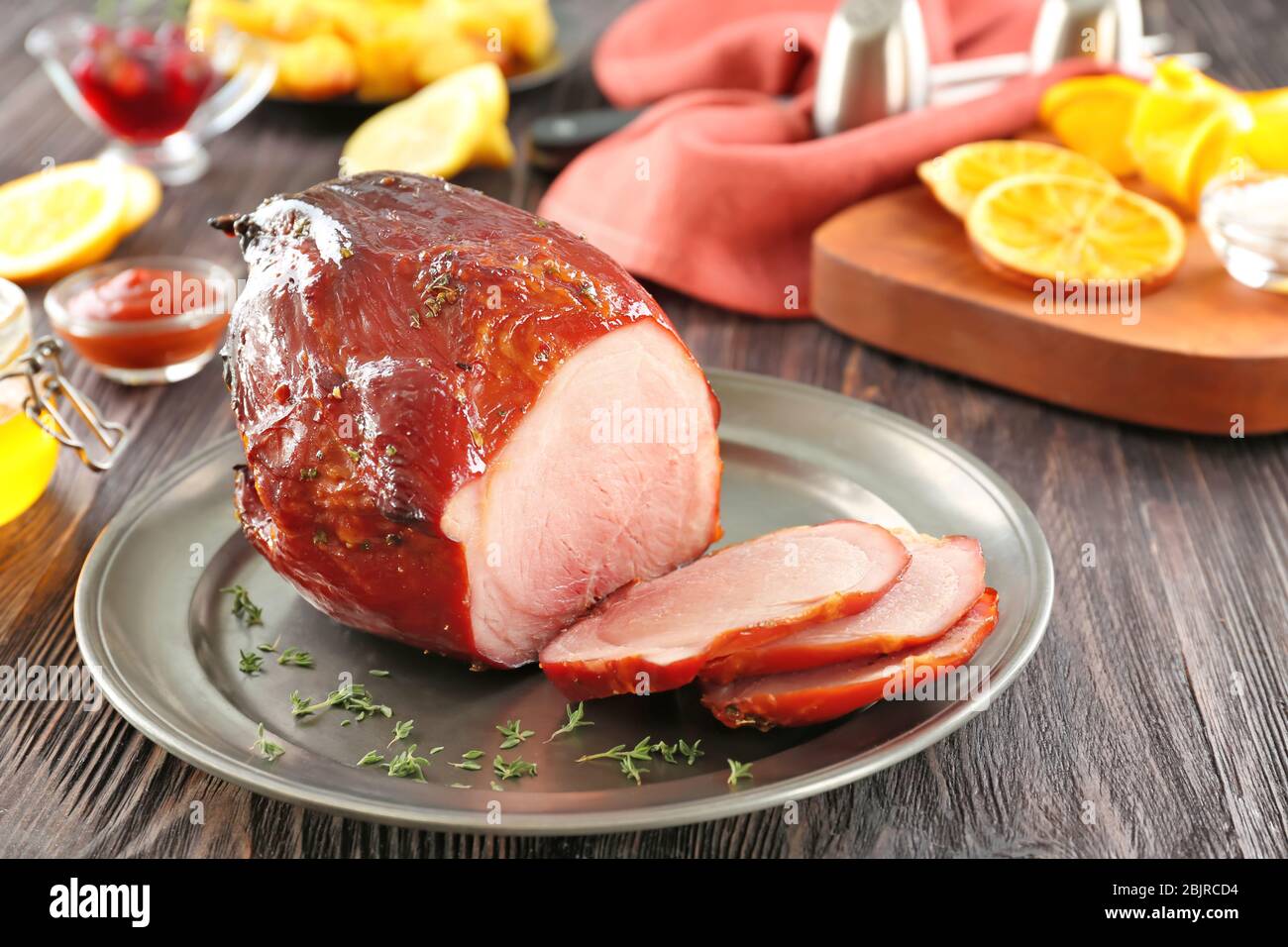 Metal plate with traditional honey baked ham on table Stock Photo - Alamy