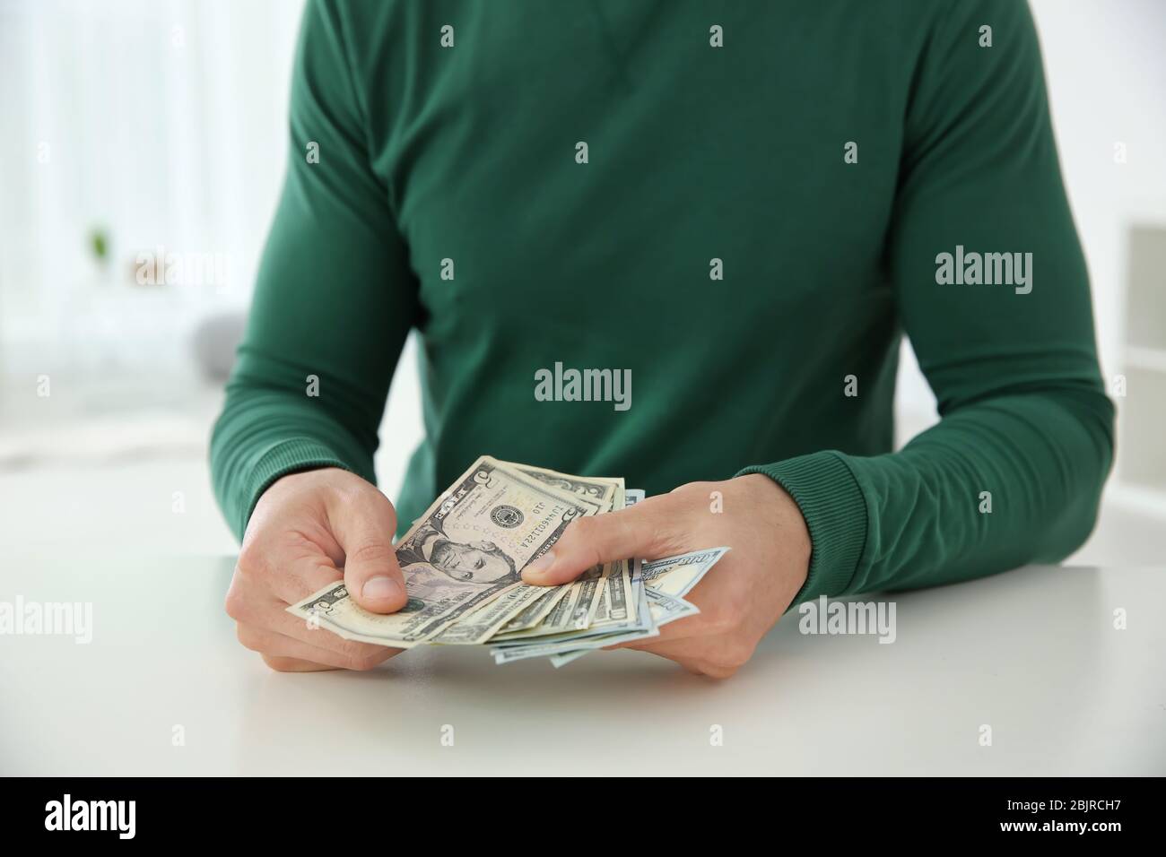 Man counting money indoors closeup hi-res stock photography and images ...