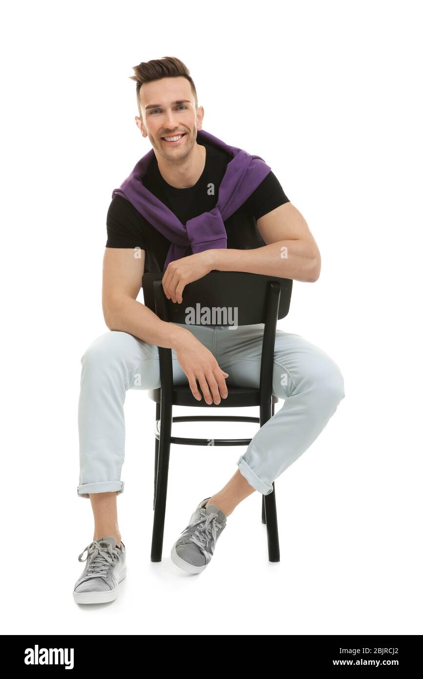 Handsome young man sitting on chair, isolated on white Stock Photo - Alamy