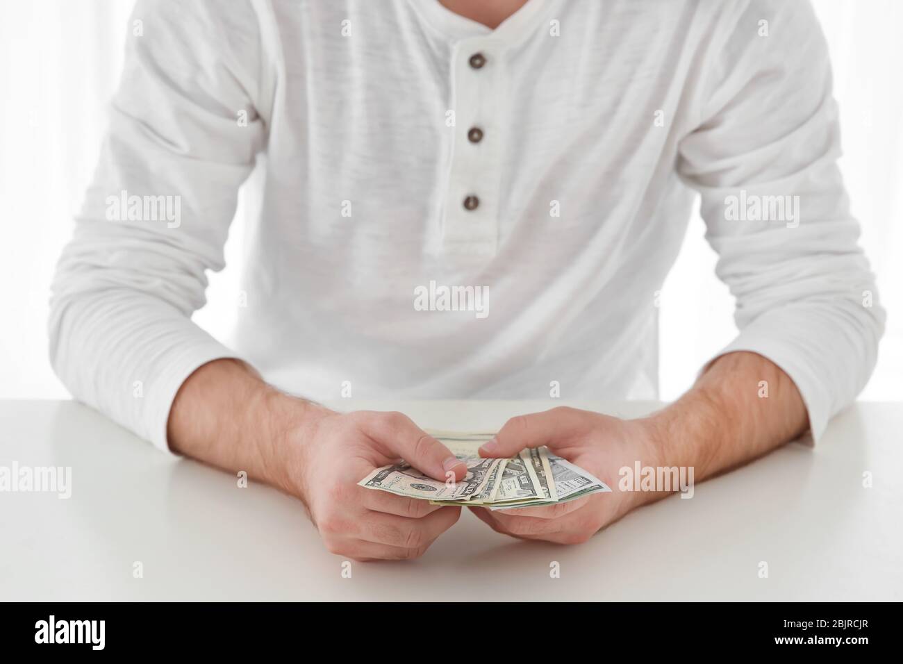 Man counting money indoors closeup hi-res stock photography and images ...