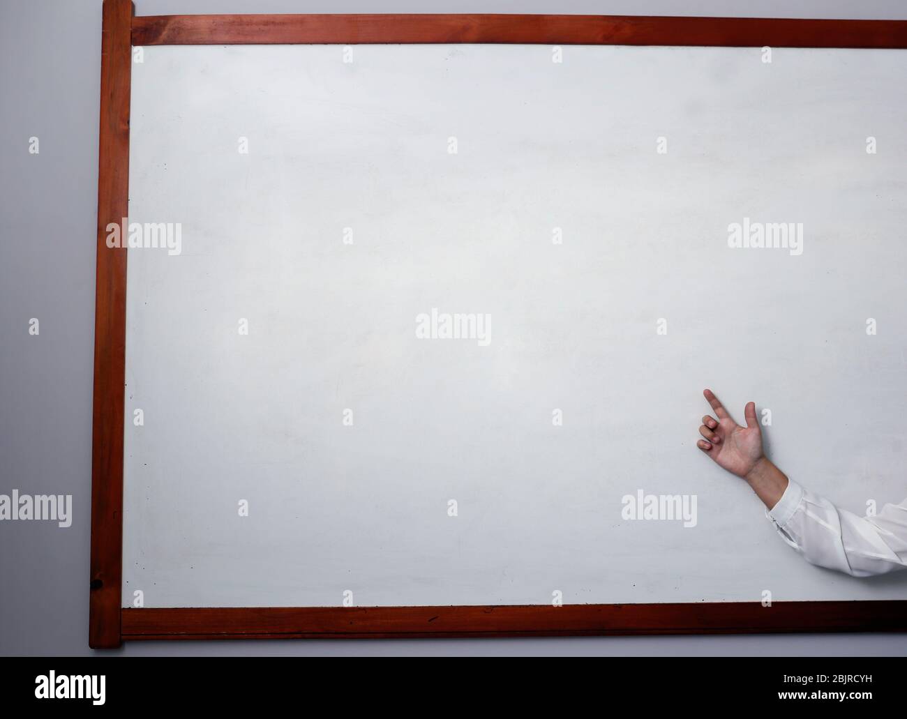 Teacher woman hand showing whiteboard in classroom Stock Photo - Alamy