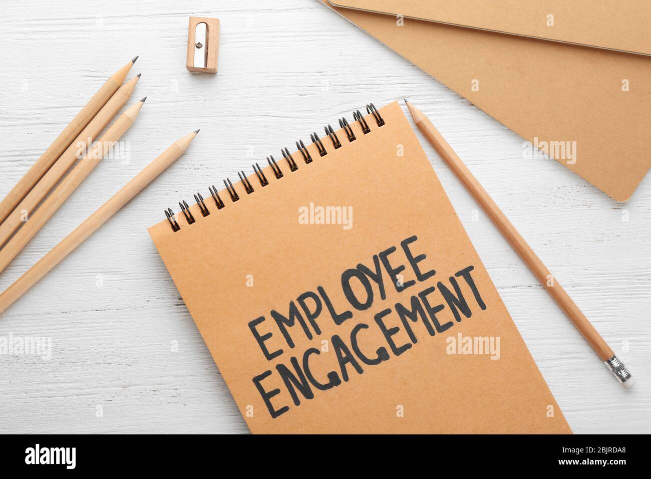 Notepad with text EMPLOYEE ENGAGEMENT on table Stock Photo - Alamy