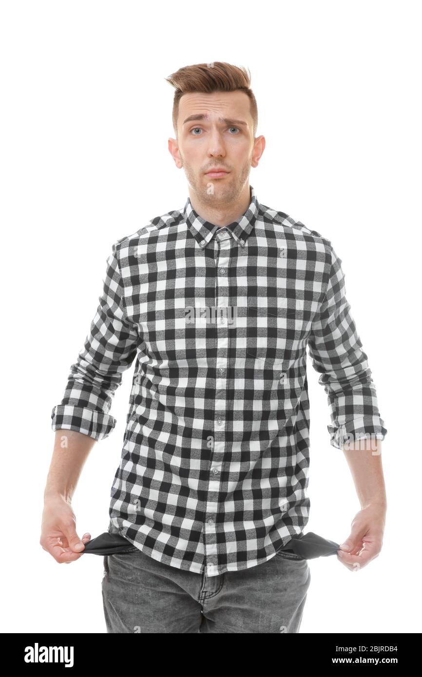 Sad young man showing his empty pockets on white background Stock Photo ...