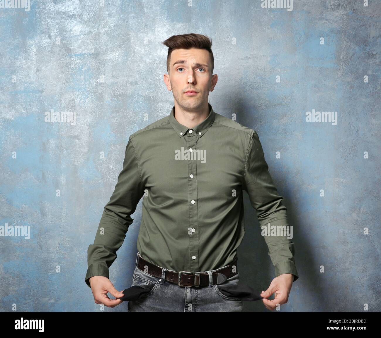 Upset man showing empty pockets hi-res stock photography and images - Alamy