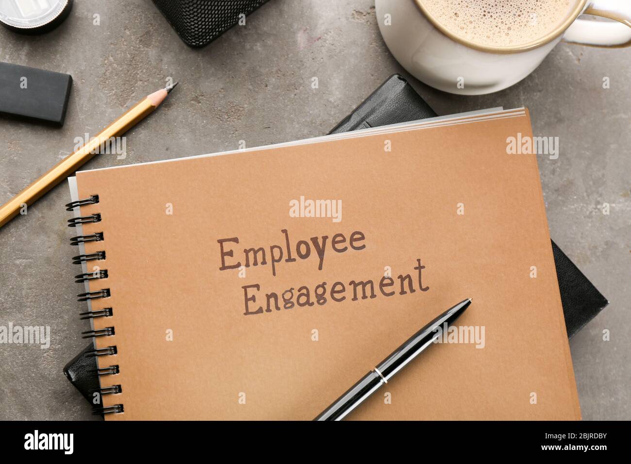 Notepad with text EMPLOYEE ENGAGEMENT on table Stock Photo - Alamy