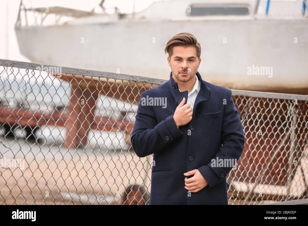 Trendy young man near fence hi-res stock photography and images - Alamy