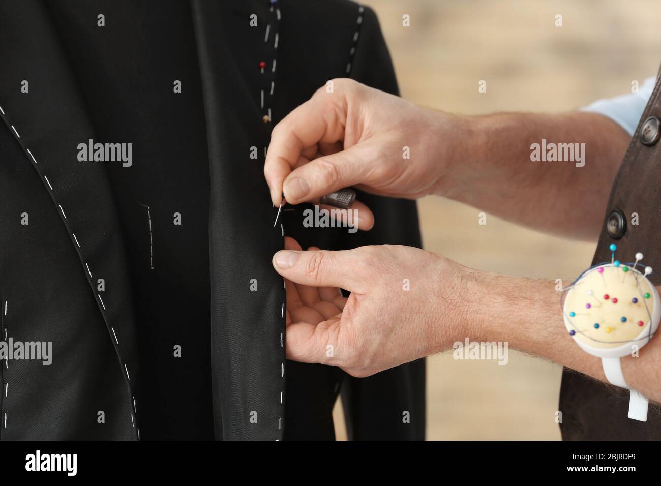 Senior man tailoring formal suit in atelier Stock Photo - Alamy