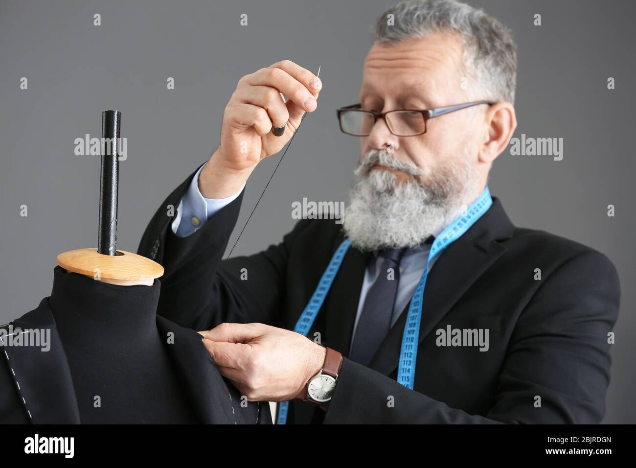 Senior man tailoring formal suit in atelier Stock Photo - Alamy