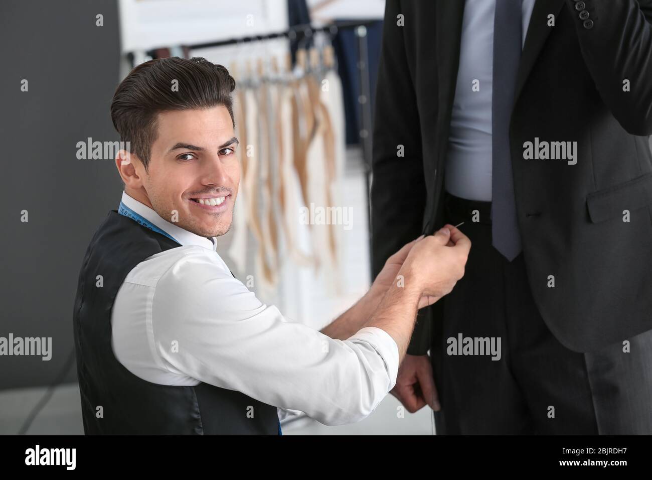 Seamster tailoring formal suit for businessman in atelier Stock Photo ...