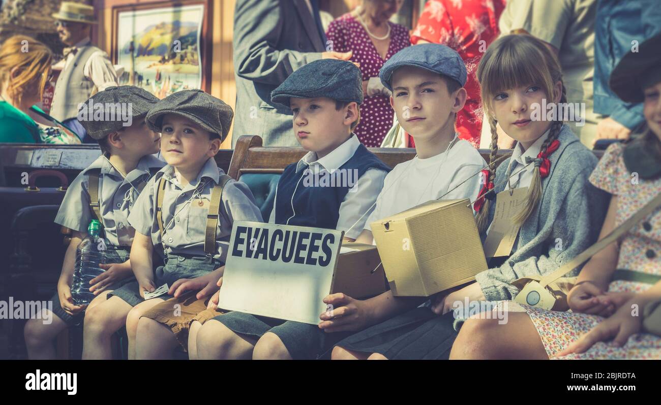 Retro, vintage front view of 1940s evacuees, ww2 children waiting at ...