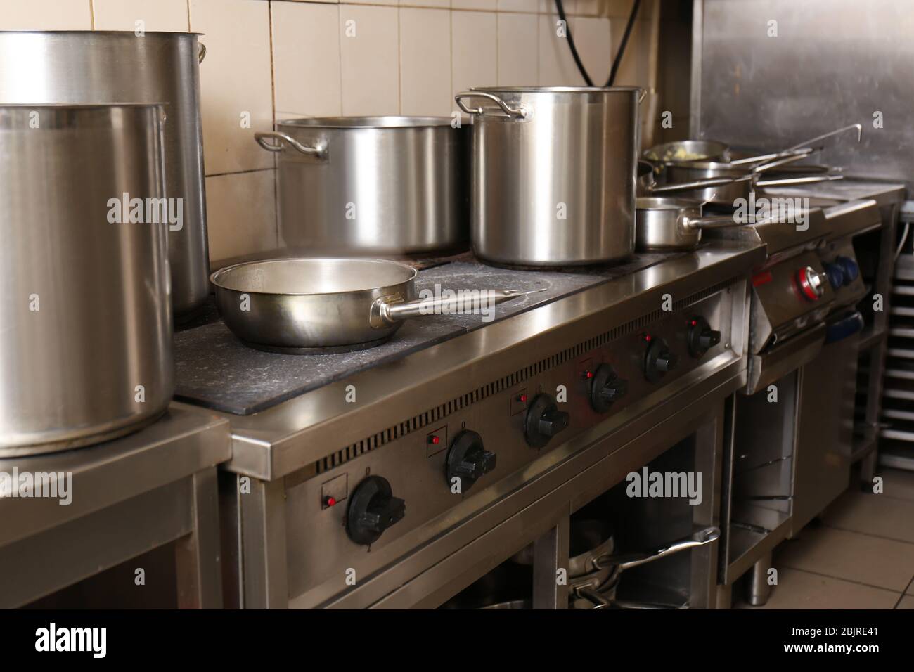 Professional equipment with cookware in restaurant kitchen Stock Photo ...
