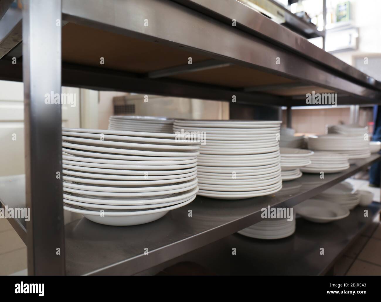 Set of clean dishes in restaurant kitchen Stock Photo - Alamy