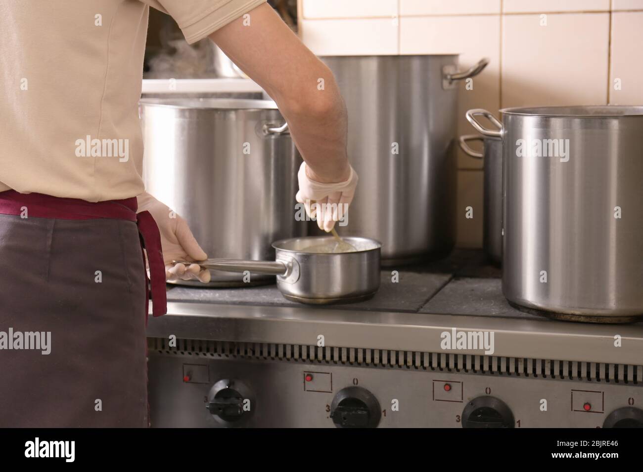 Male chef cooking in restaurant kitchen Stock Photo - Alamy