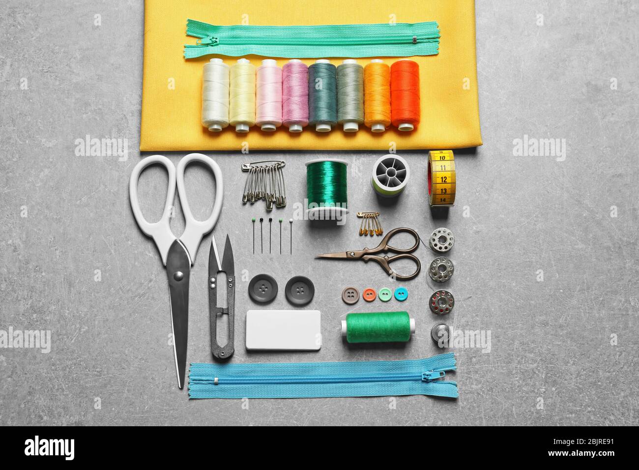 Set of tailoring tools and accessories on table, top view Stock Photo ...