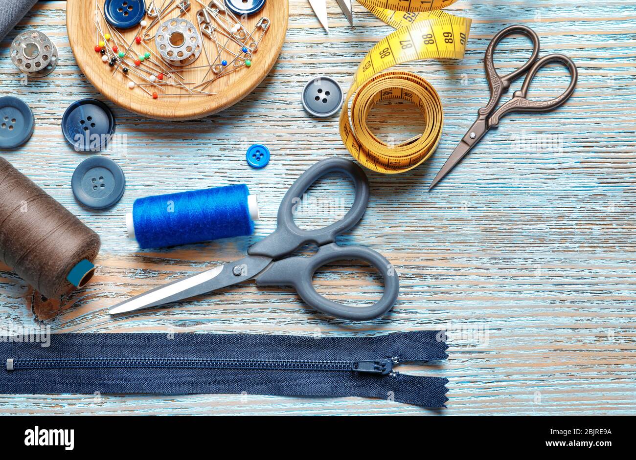 Set of tailoring tools and accessories on table, top view Stock Photo ...
