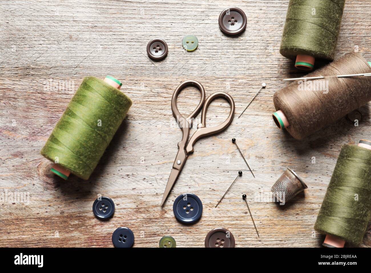 Set of tailoring tools and accessories on table, top view Stock Photo ...